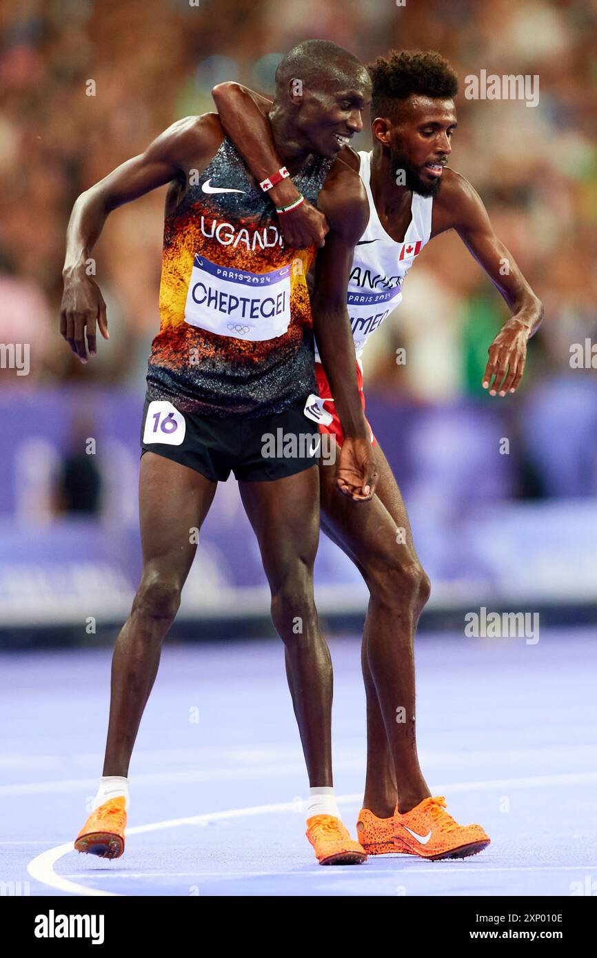 Joshua Cheptegei of Team Uganda and Mohammed Ahmed of Team Canada ...
