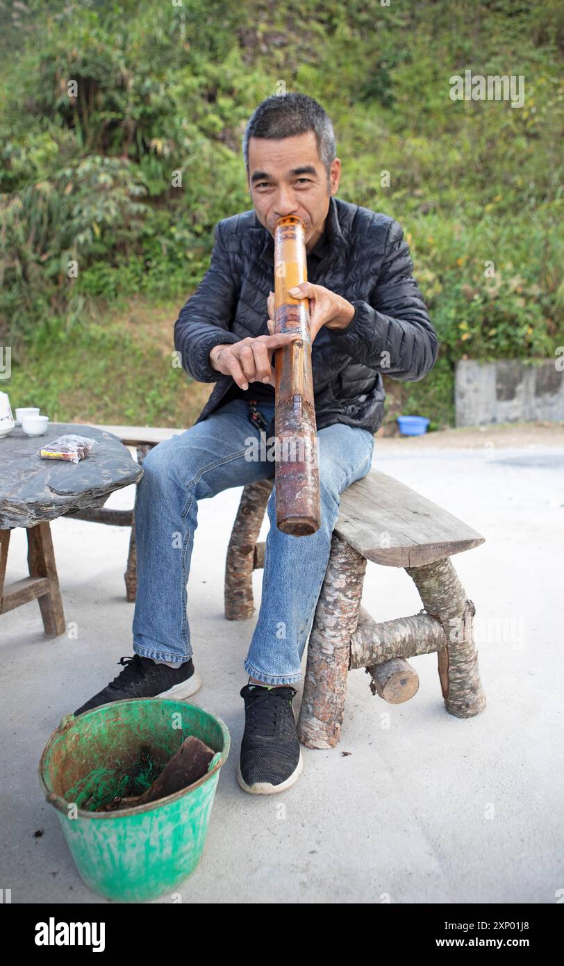 Vietnamese man smoking a thick bamboo pipe, Ha Giang province, Vietnam ...