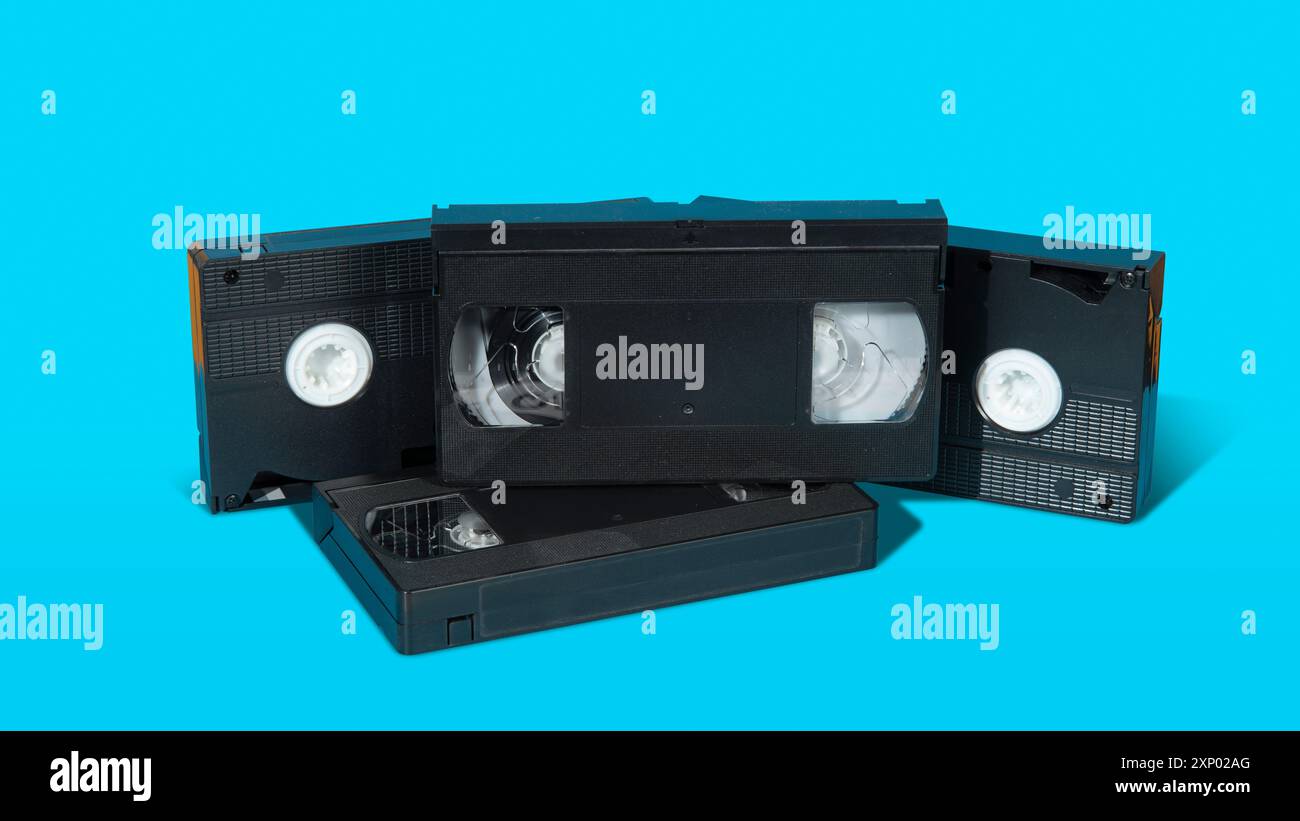 Front view of old black plastic VHS video cassette with on a blue ...