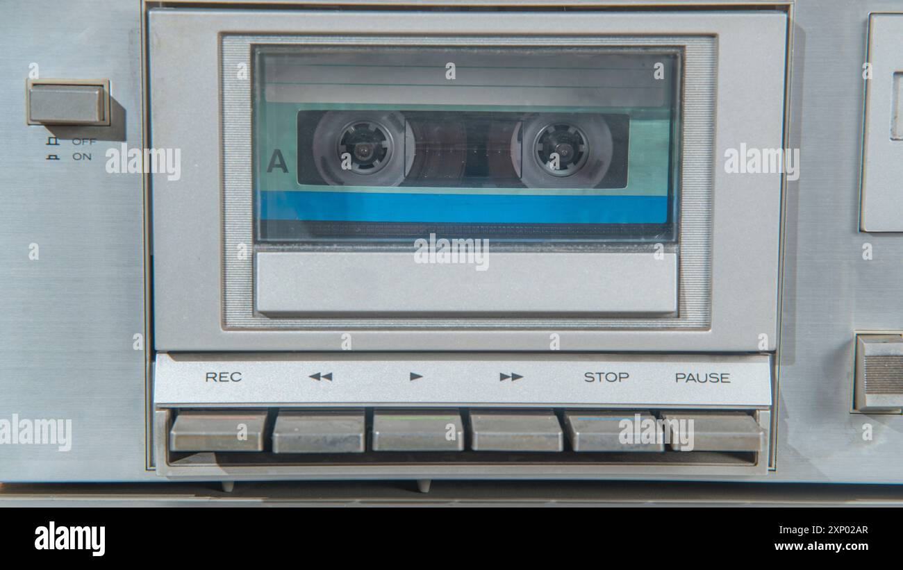 Front view of old music cassette inside an old aluminum recorder Stock ...
