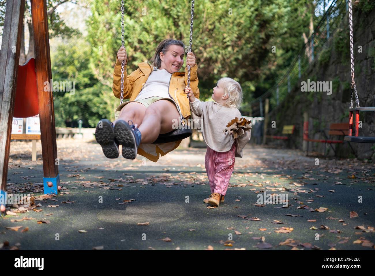 Smiling mother and daughter having good time on the playground Stock ...