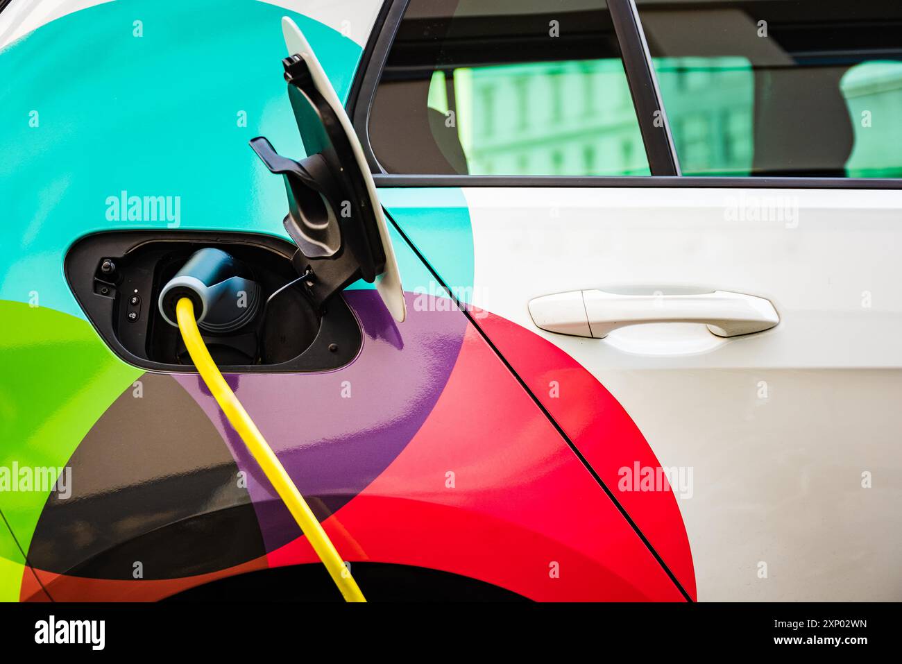 Charging battery of an electric car in city. Closup of cable Stock ...