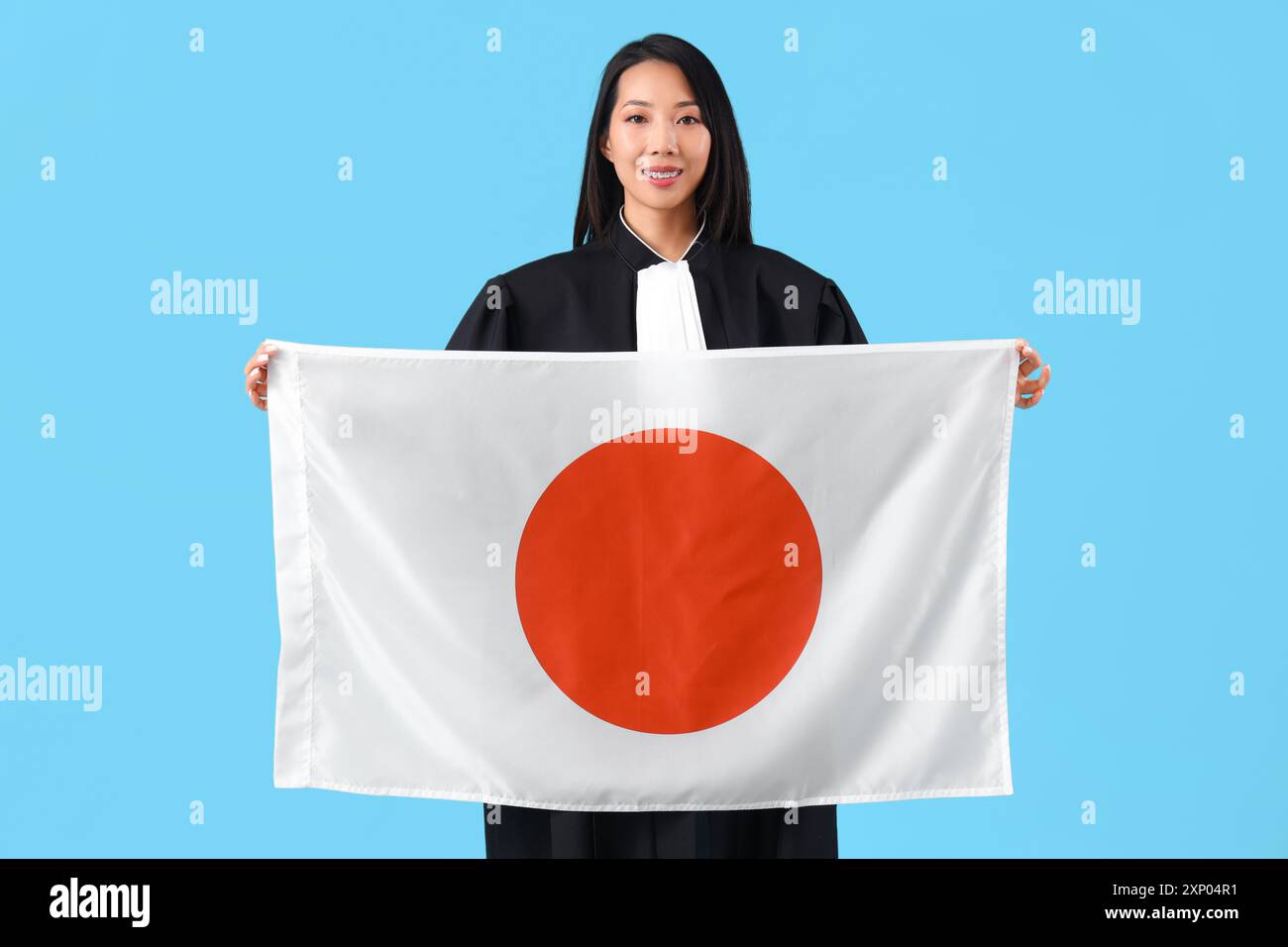 Female Asian judge with flag of Japan on blue background Stock Photo ...