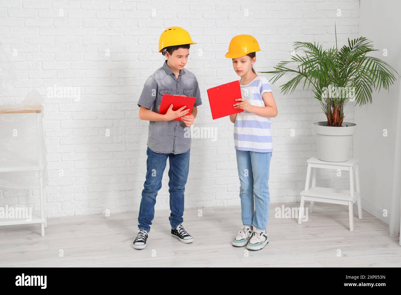 Little architects with clipboards in room Stock Photo - Alamy
