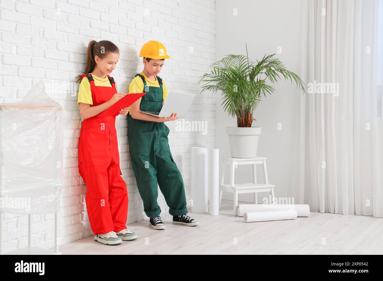 Little architects with laptop and clipboard in room Stock Photo - Alamy
