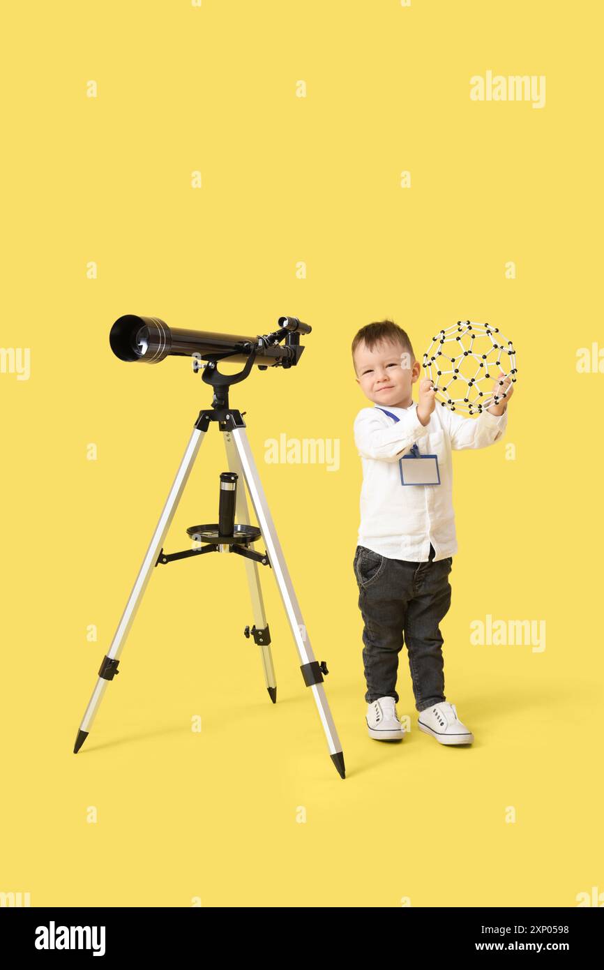 Cute little scientist with telescope and molecular model on yellow ...