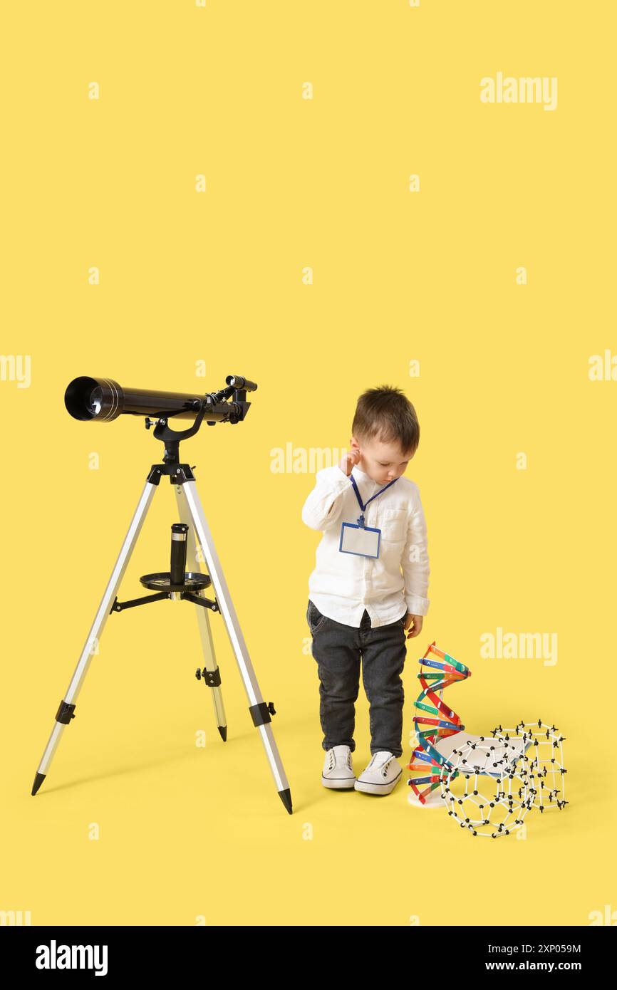 Cute little scientist with telescope, DNA and molecular model on yellow ...