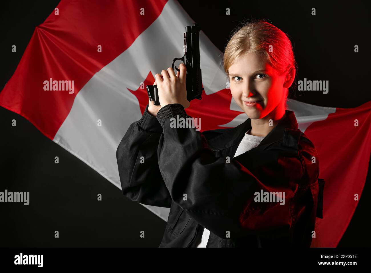 Female police officer with gun and flag of Canada on dark background ...