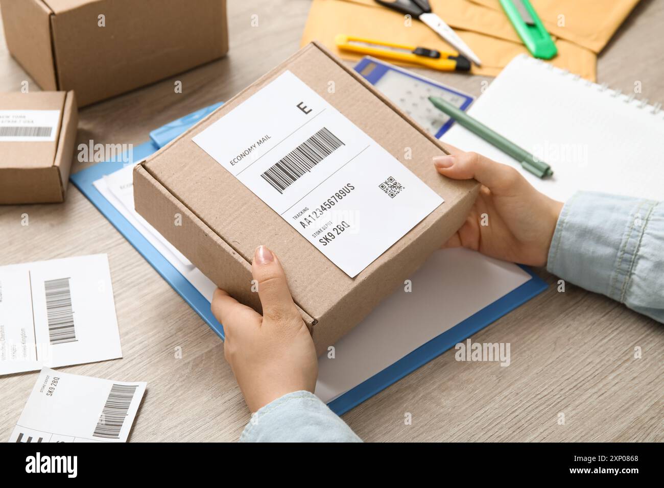 Female postal worker parcel hi-res stock photography and images - Alamy