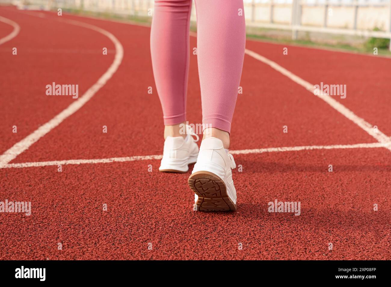Woman going along starting line at stadium. Concept of new beginning ...