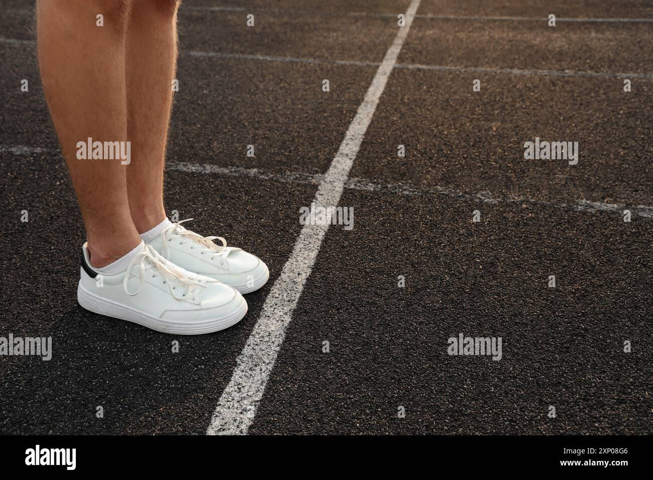Man standing on stadium road with starting line. Concept of new ...