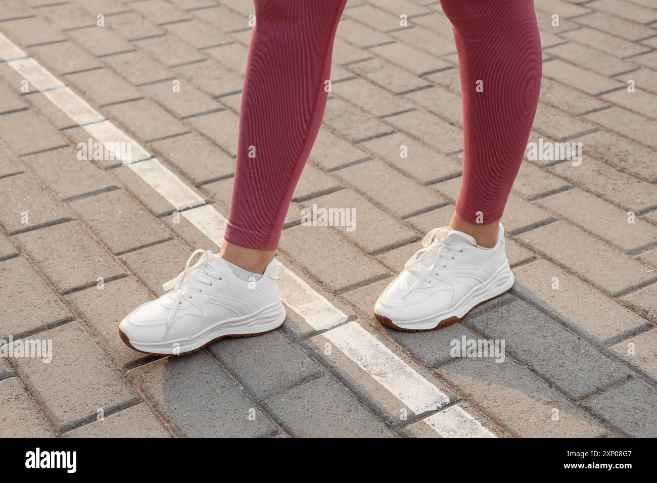 Woman walking over starting line on paved road. Concept of new ...