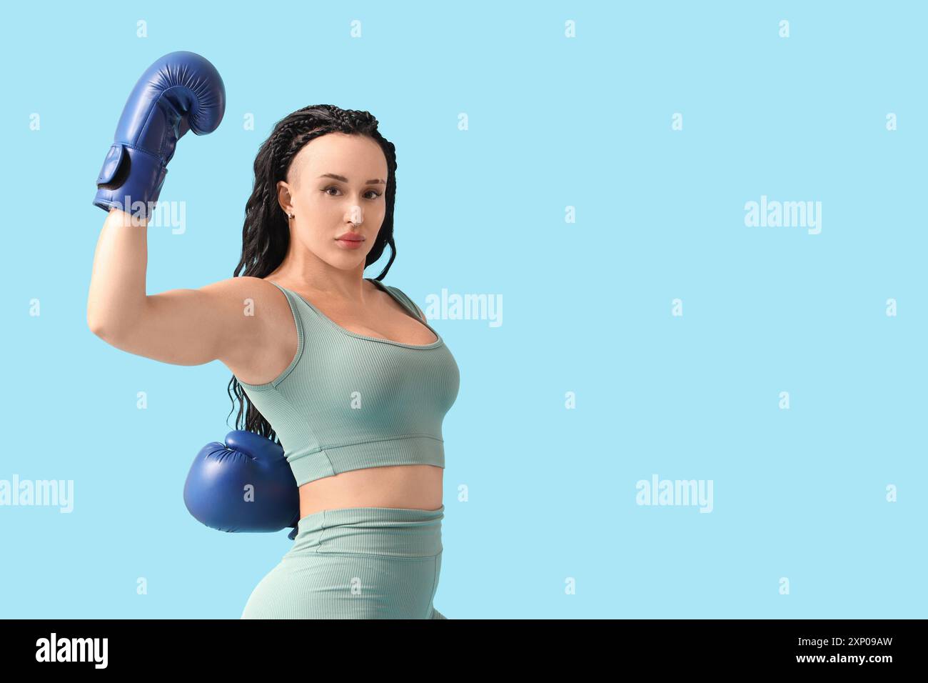 Female bodybuilder in boxing gloves on blue background Stock Photo - Alamy