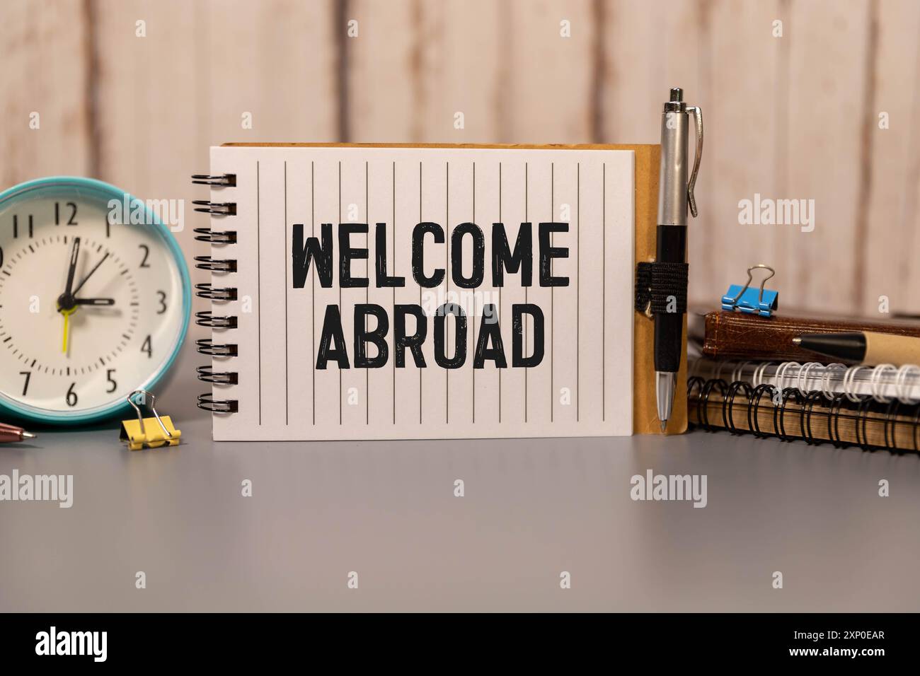 WORKING ABROAD text written on yellow paper with notebook Stock Photo ...