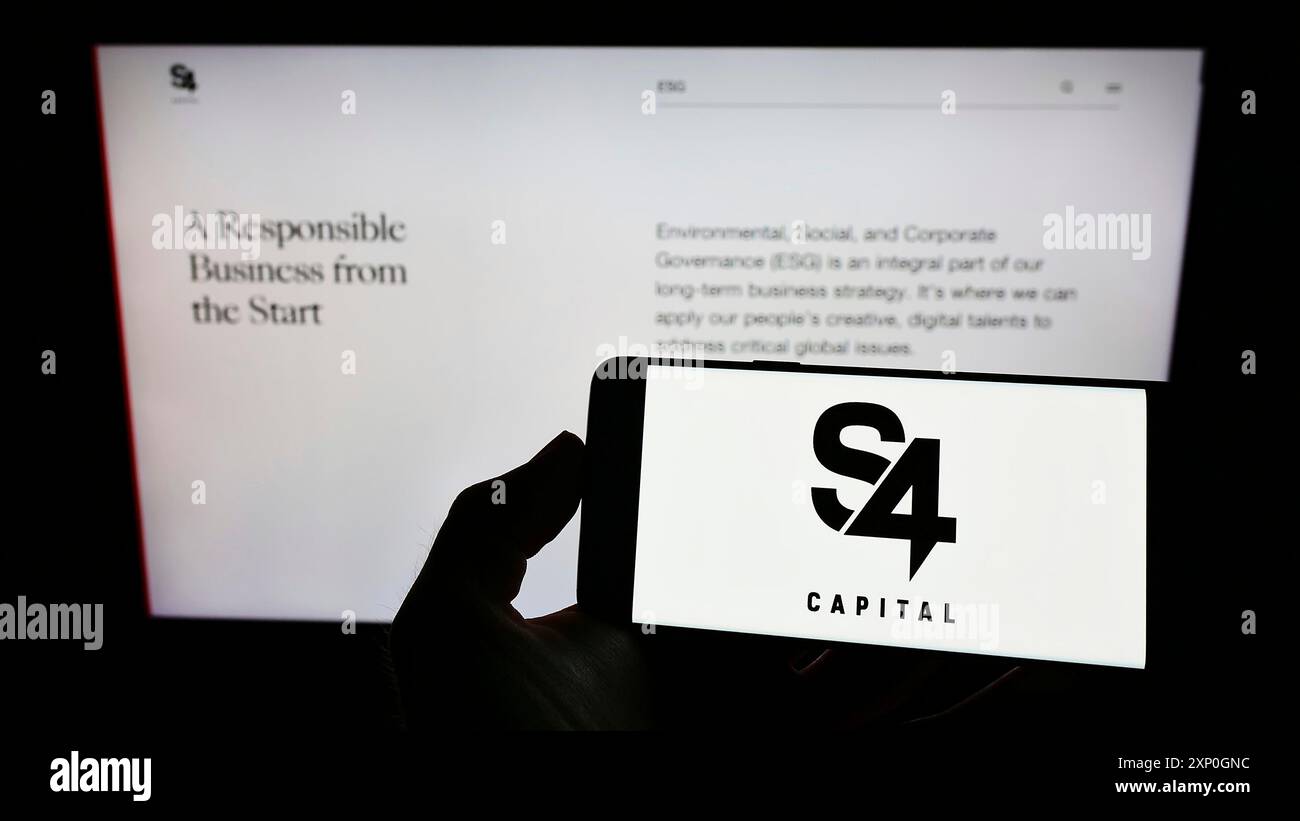 Stuttgart, Germany, 02-26-2022: Person holding smartphone with logo of ...