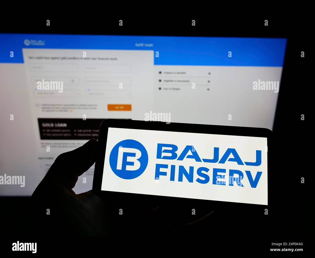 Stuttgart, Germany, 01-23-2022: Person holding cellphone with logo of Indian financial company ...
