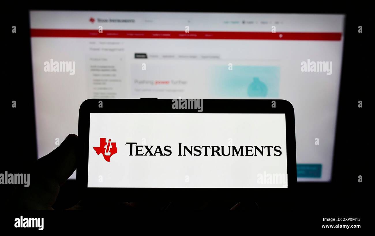 Stuttgart, Germany, 12-01-2022: Person holding cellphone with logo of American company Texas ...