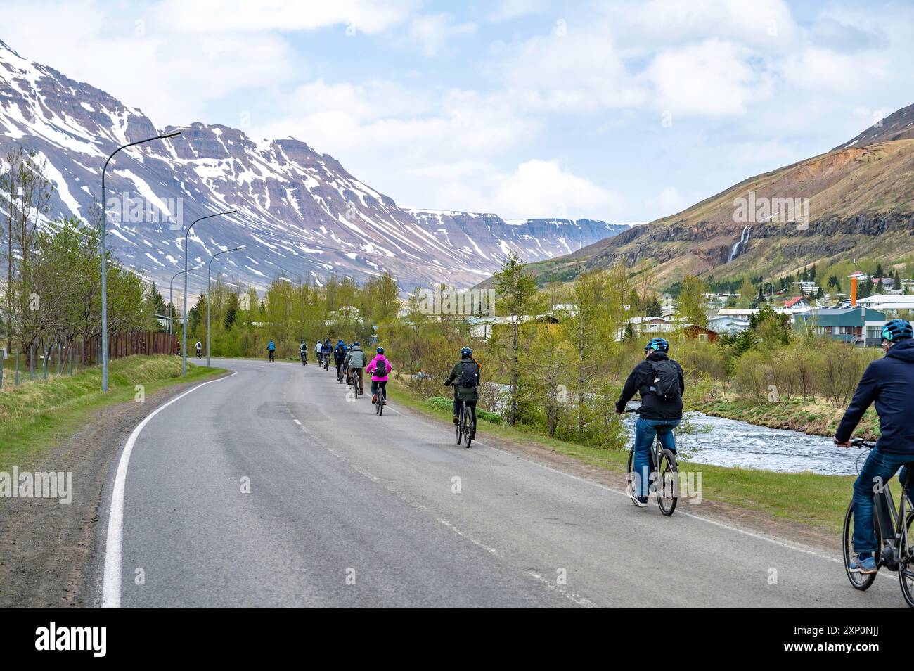 Group of cyclists on the road at Seydisfjordur, Iceland doing a side ...