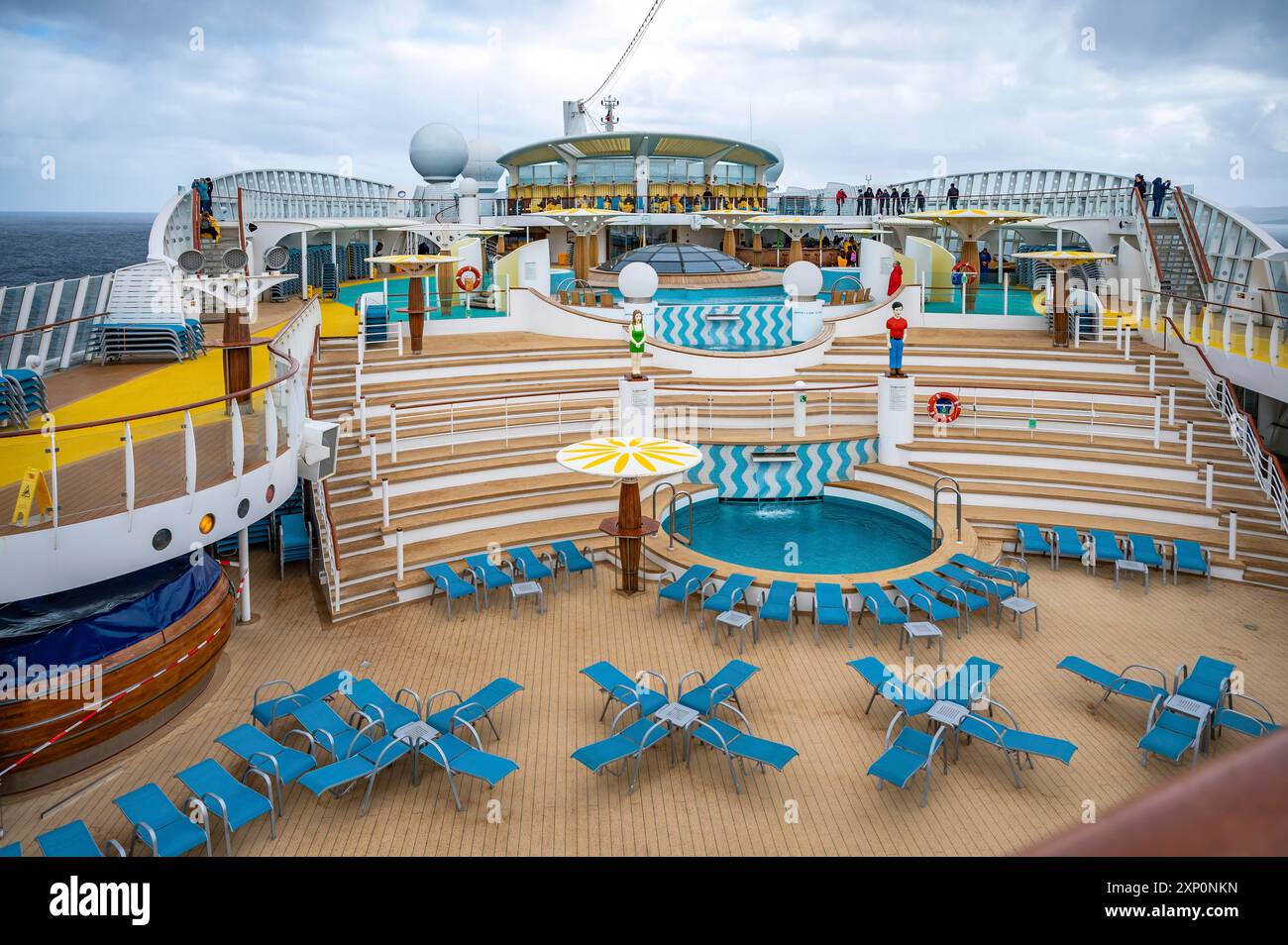 Boat deck of AIDA Bella during cloudy day, lots of deck chairs on the ...