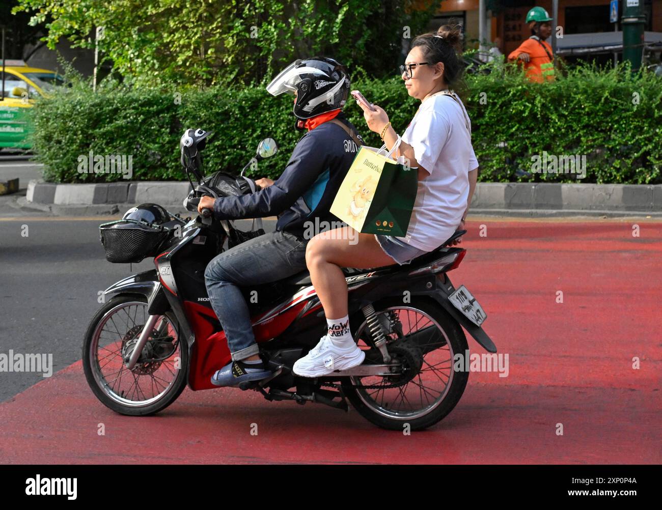 Scooter driver Passenger Stock Photo - Alamy