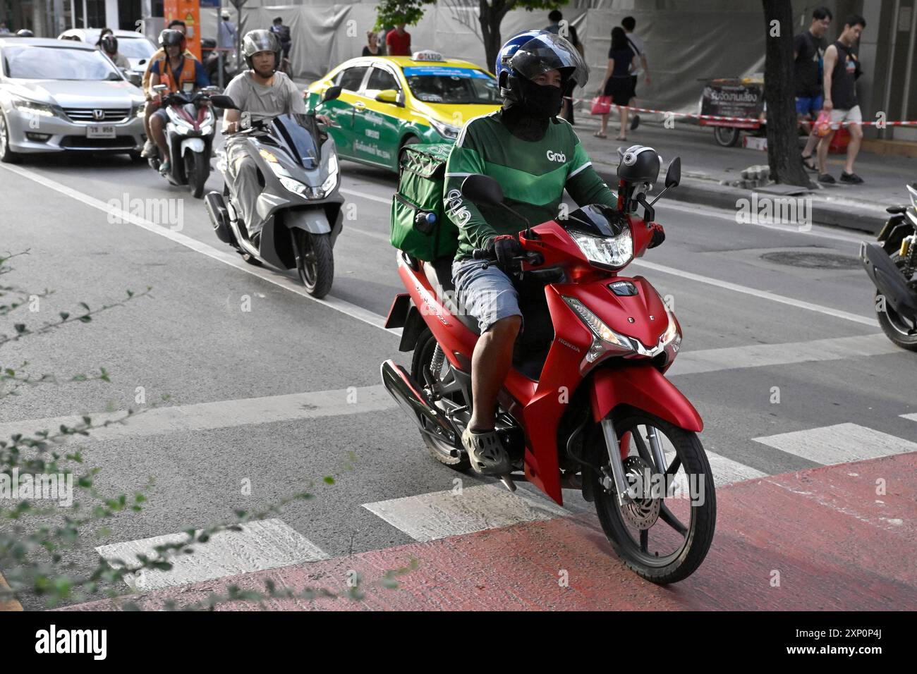 Grab scooter rider Stock Photo - Alamy