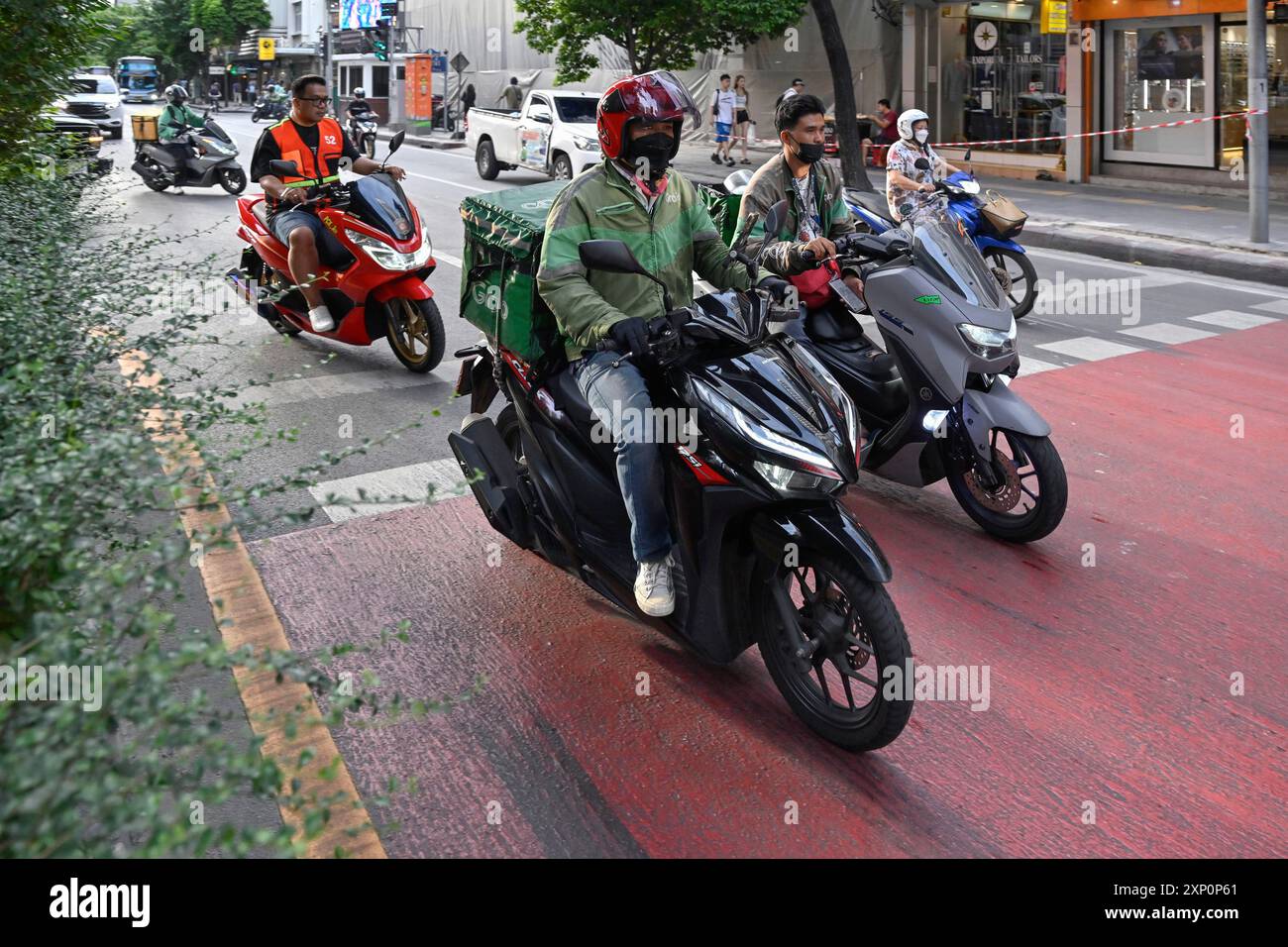 Grab scooter rider Stock Photo - Alamy