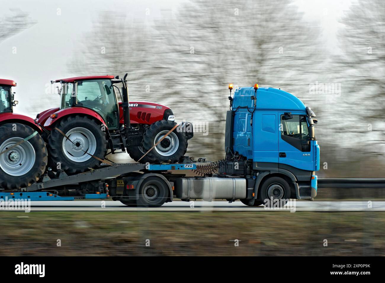 Truck, lorry, articulated lorry with new tractors driving fast on the ...