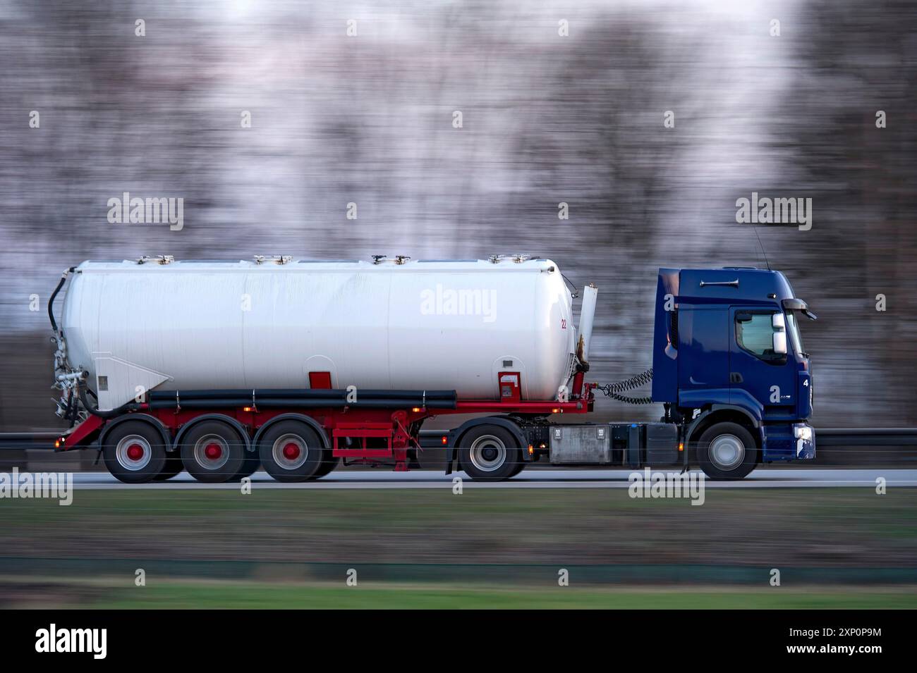 Truck, lorry, articulated lorry with tanker trailer driving fast on the ...