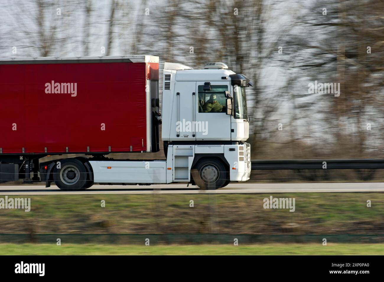 Unconcentrated driver in truck, lorry, articulated lorry driving fast ...