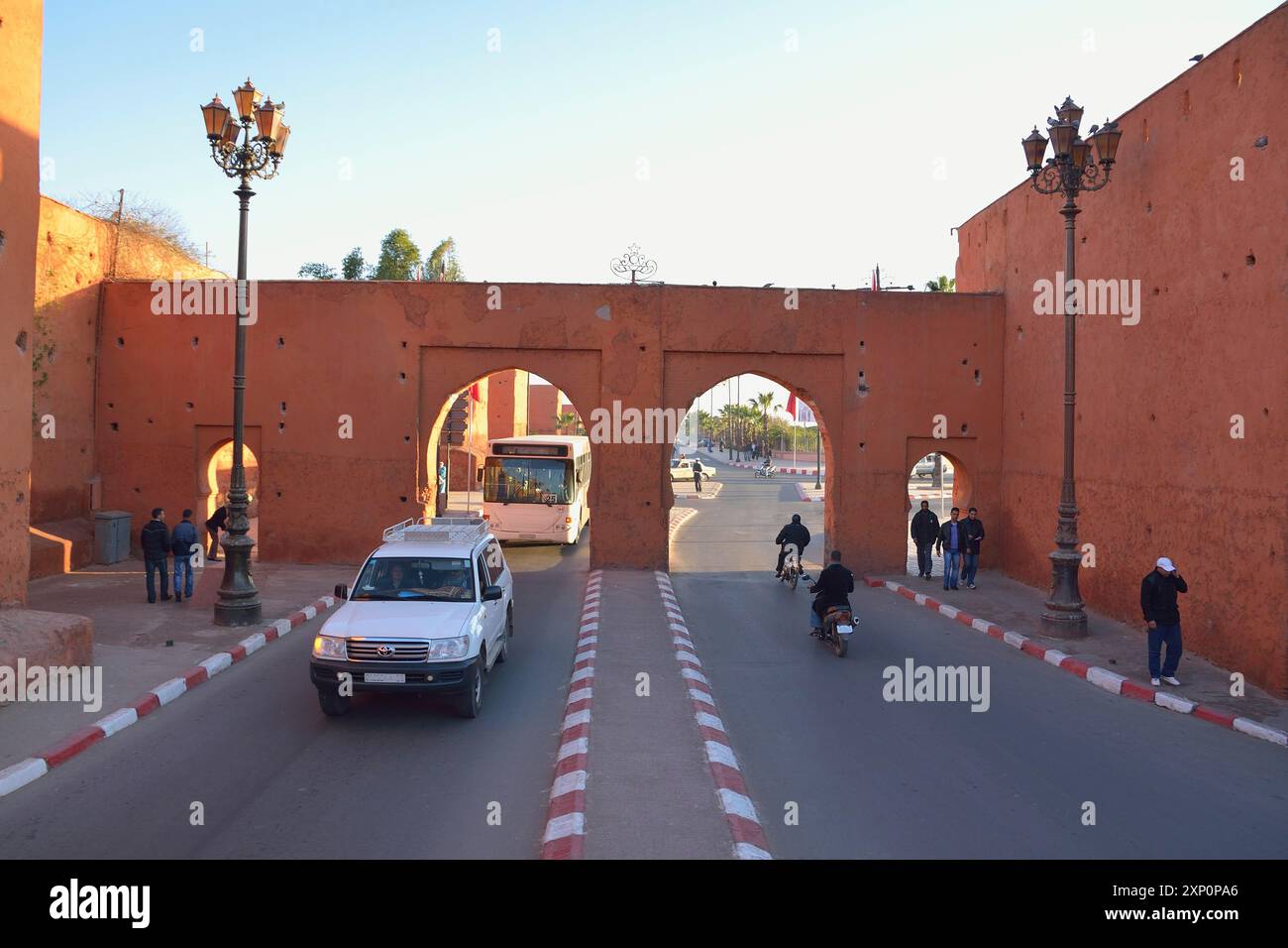 A city gate with four arches in a Moroccan city, vehicles and ...