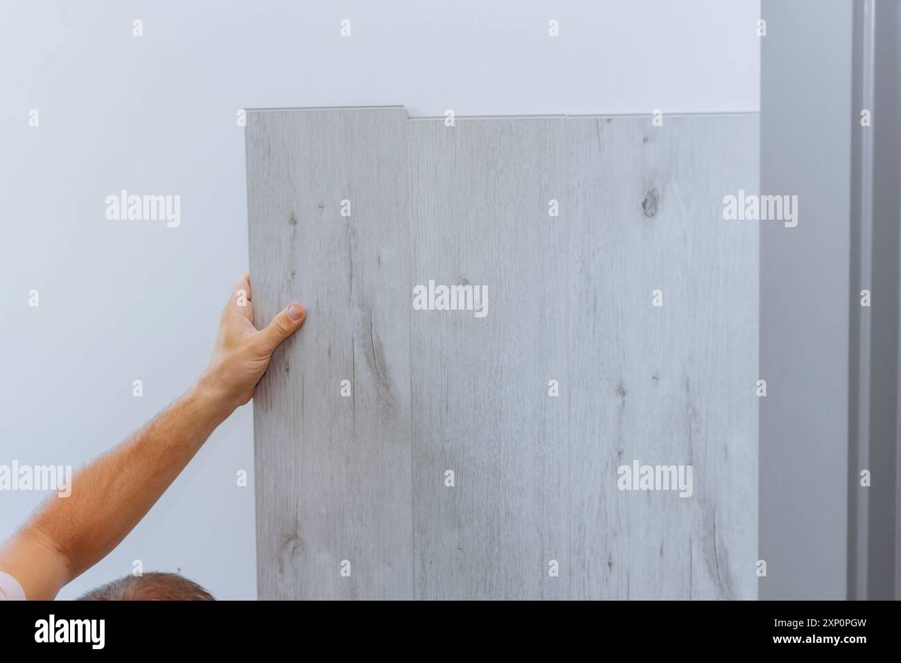 Installation of laminated panels on wall at room house during ...