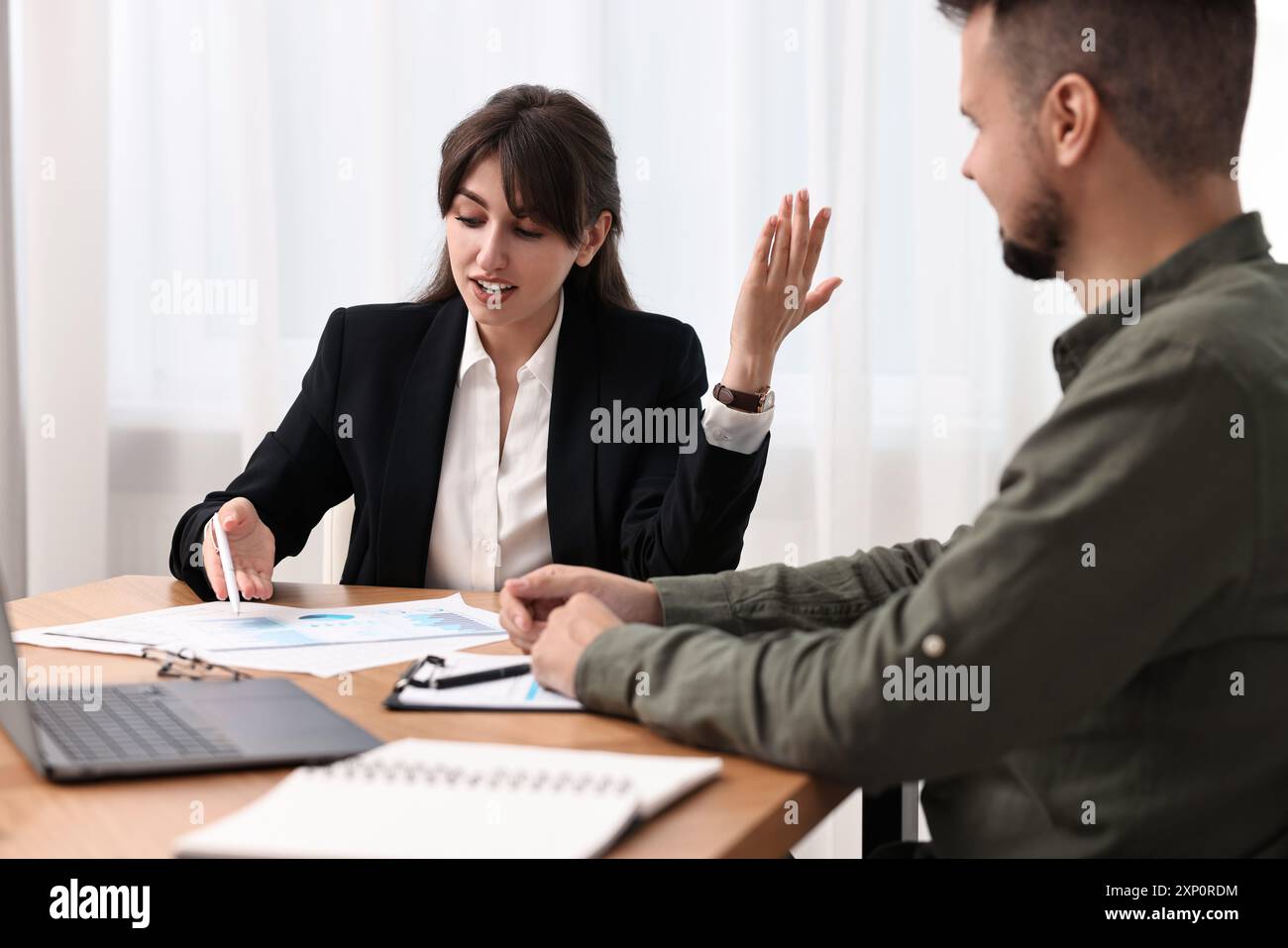 Consultant working with partner at table in office. Business meeting ...