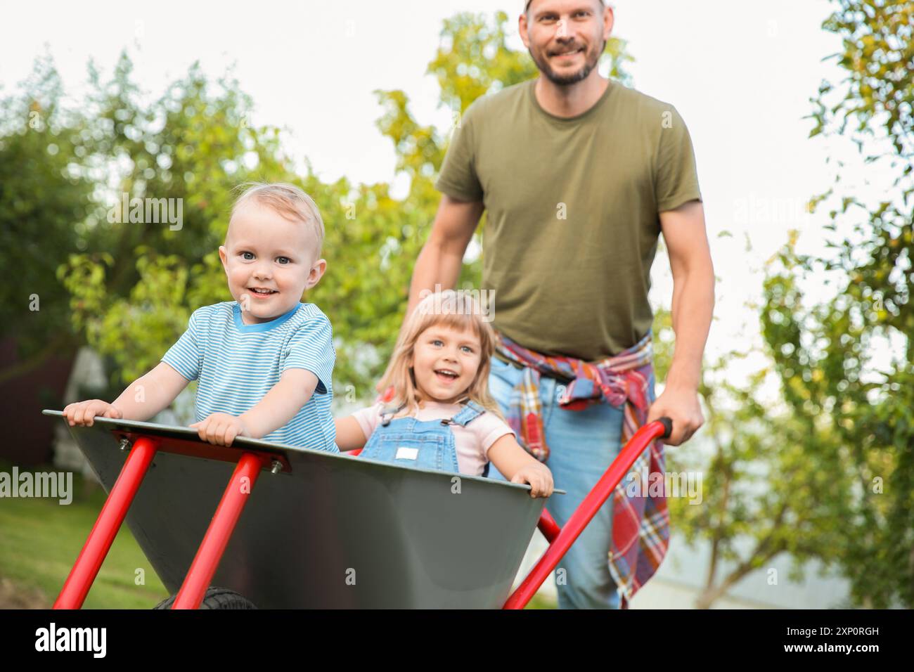 Happy male farmer wheelbarrow hi-res stock photography and images - Alamy
