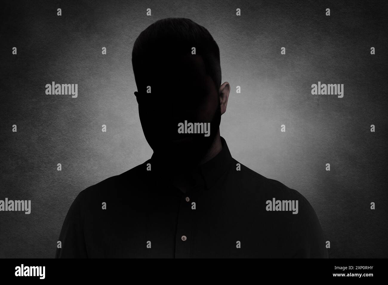 Anonymous person. Shaded portrait of man on grey gradient background ...
