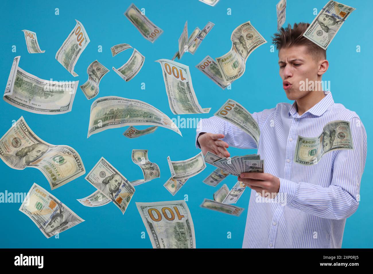Man throwing money on light blue background. Dollar bills in air Stock ...