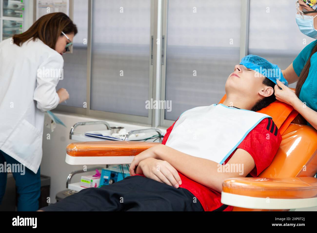 Young male patient being prepared for a skin lesion removal procedure ...