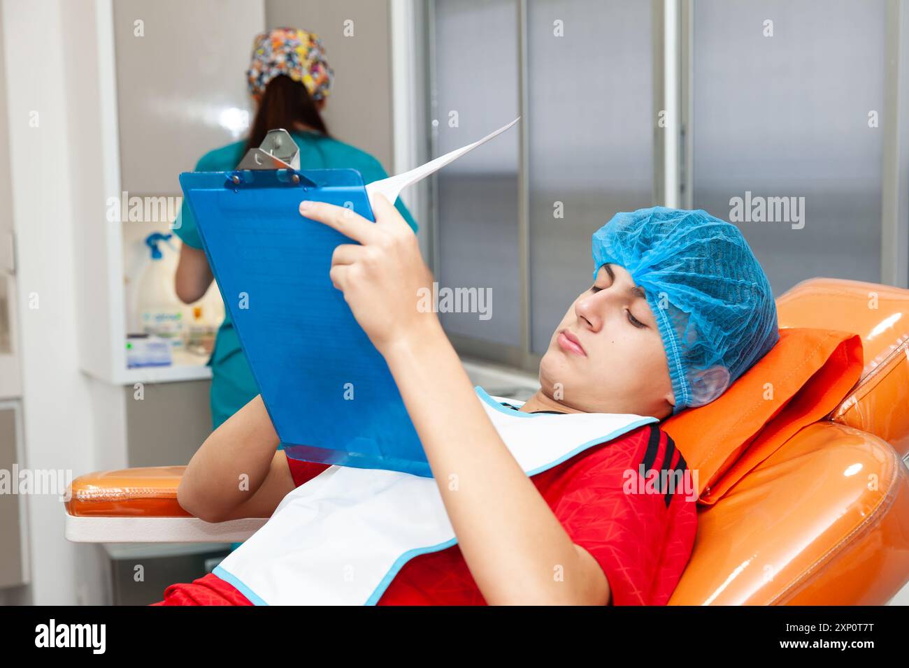 Young male patient reading an informed consent just before getting a ...