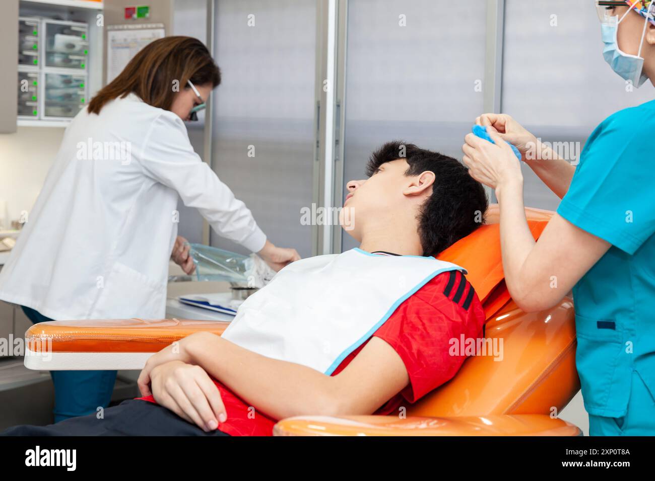 Young male patient being prepared for a skin lesion removal procedure ...