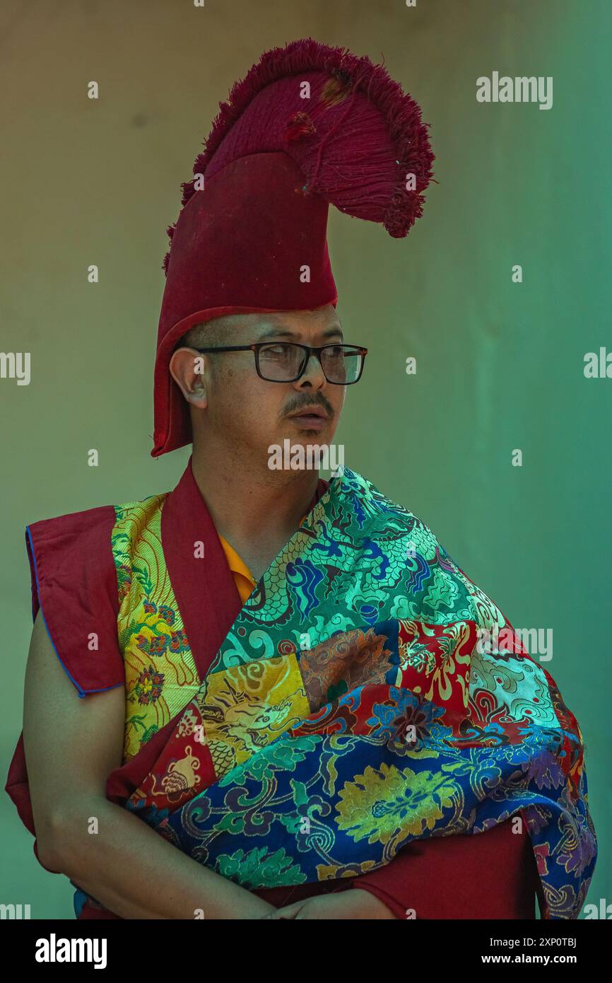 A Buddhist man dressed in traditional costume an hat in a festival at ...