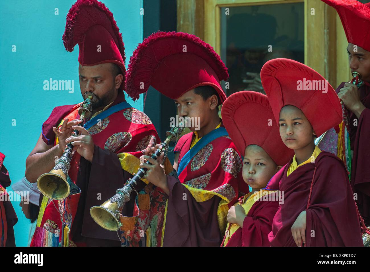 Ladakhi monks in a cultural festival playing musical instrument wearing ...