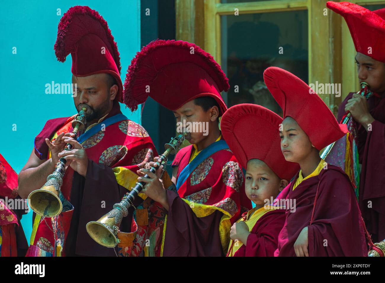 Ladakhi monks in a cultural festival playing musical instrument wearing ...