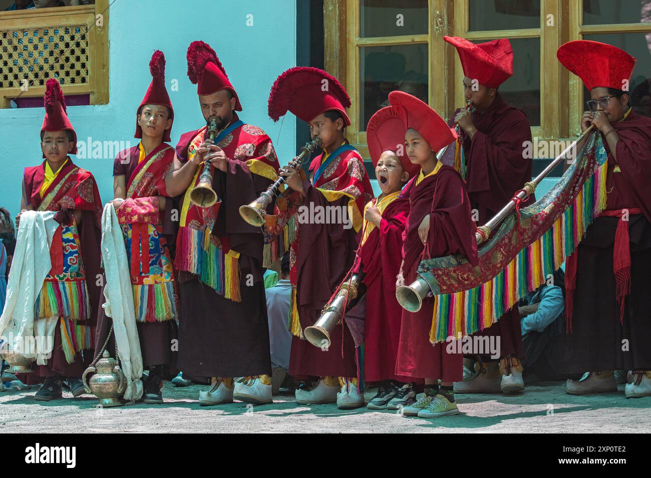 Ladakhi monks in a cultural festival playing musical instrument wearing ...