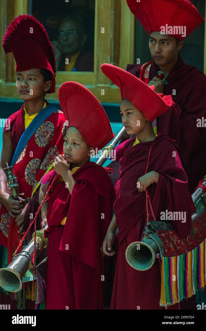 Ladakhi monks in a cultural festival playing musical instrument wearing ...