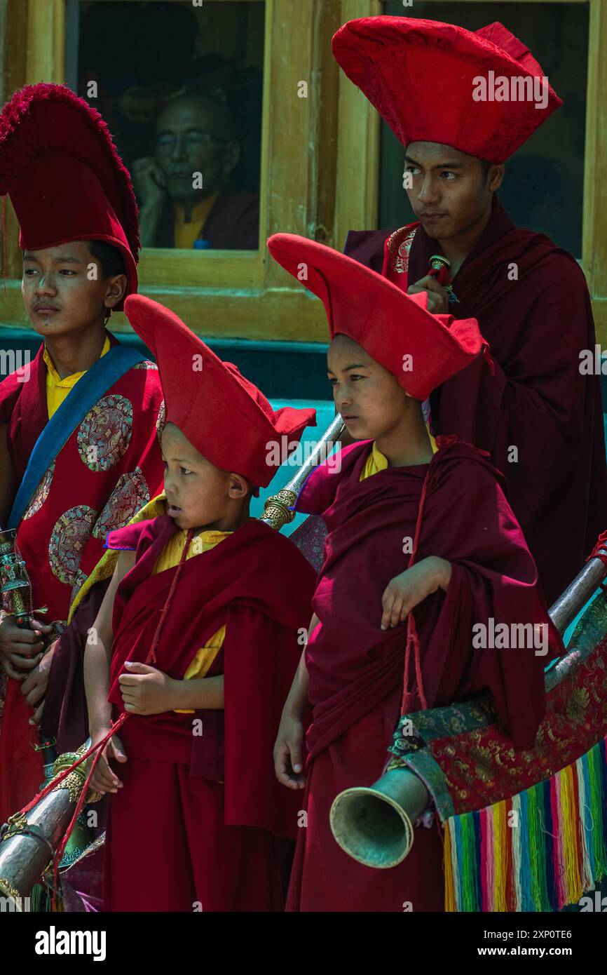 Ladakhi monks in a cultural festival playing musical instrument wearing ...