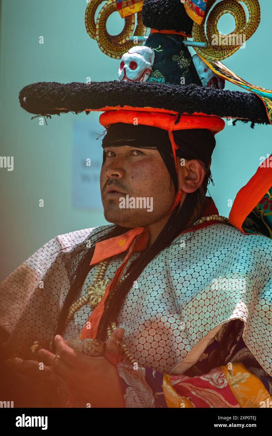 A Buddhist man dressed in traditional costume an hat in a festival at ...