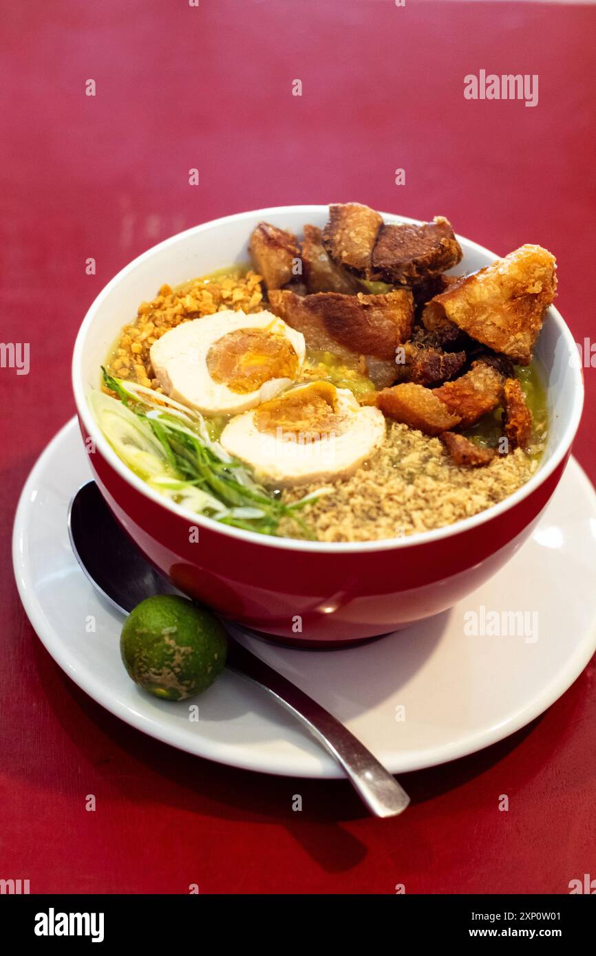 A hot bowl of mami, a popular Filipino noodle dish topped with sliced ...
