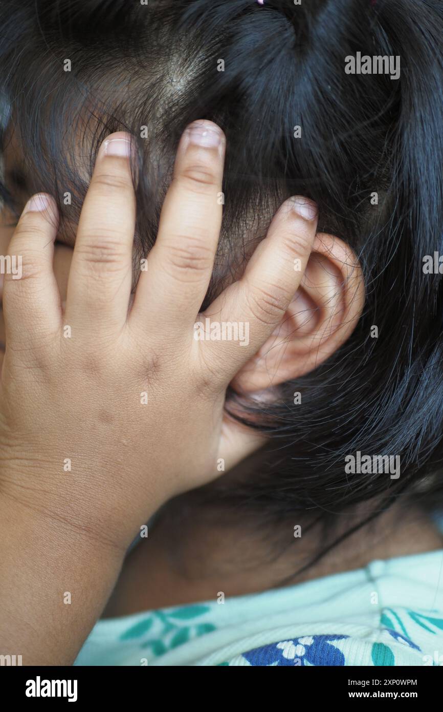 child having ear pain touching his painful ear Stock Photo - Alamy