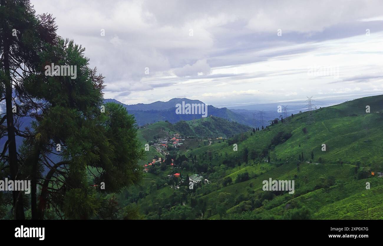 panoramic view of cloudy and foggy lush green himalayan mountain ...