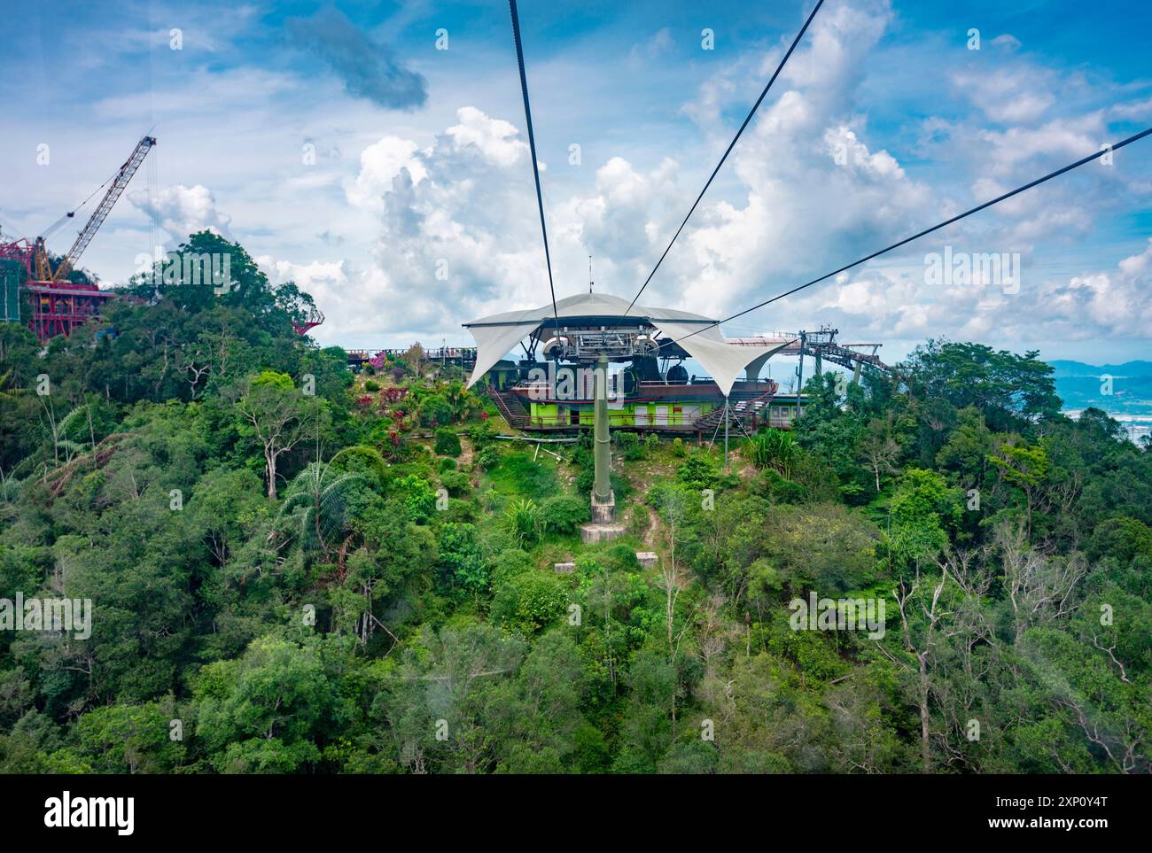 Looking through the front glass of a small gondola lift,at a major ...