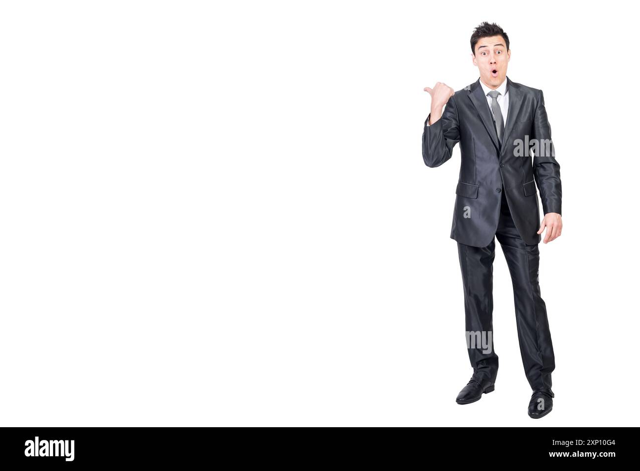 Surprised man pointing aside in studio. White background Stock Photo ...